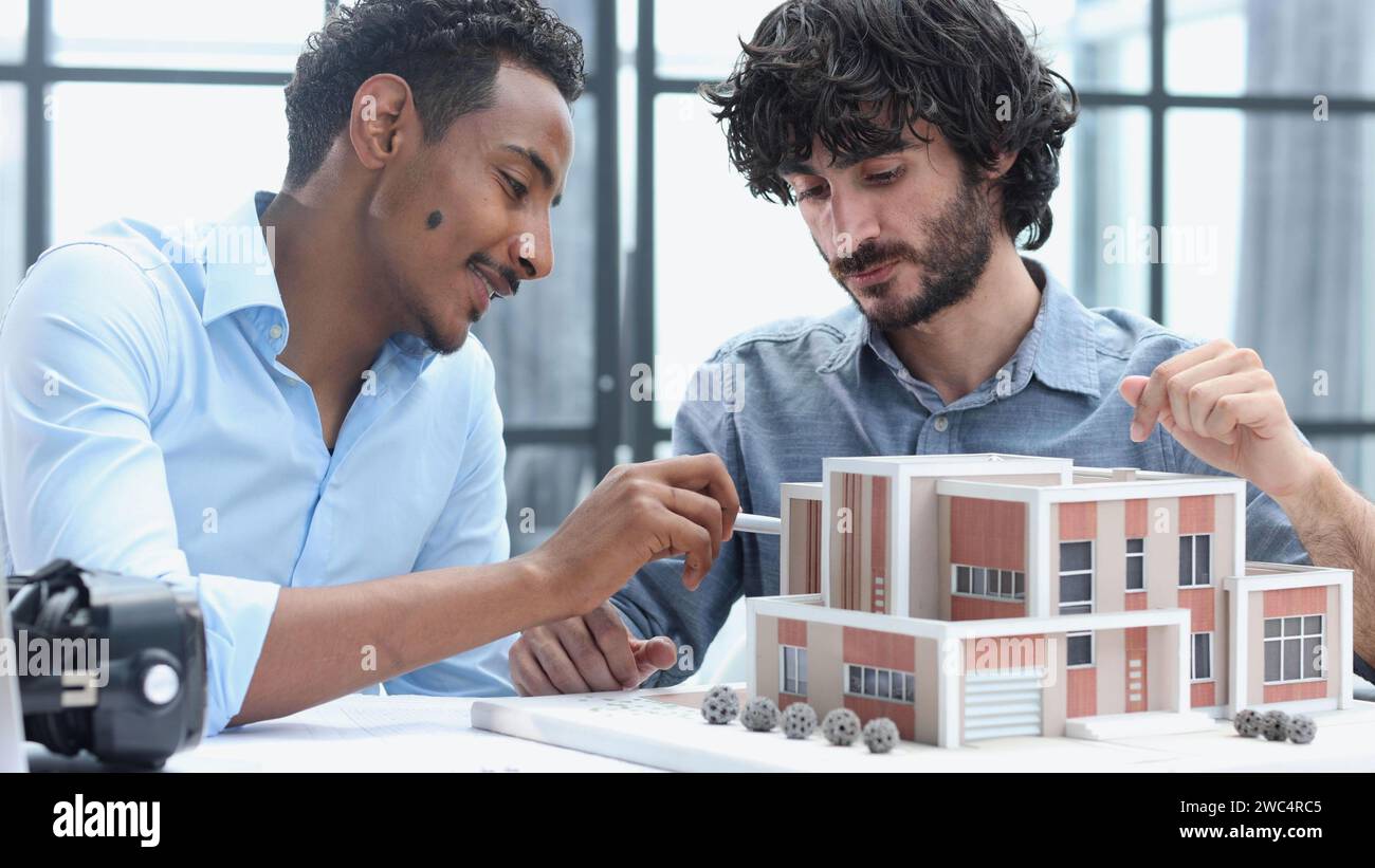 Colleagues architects are discussing the layout of the house in the ...