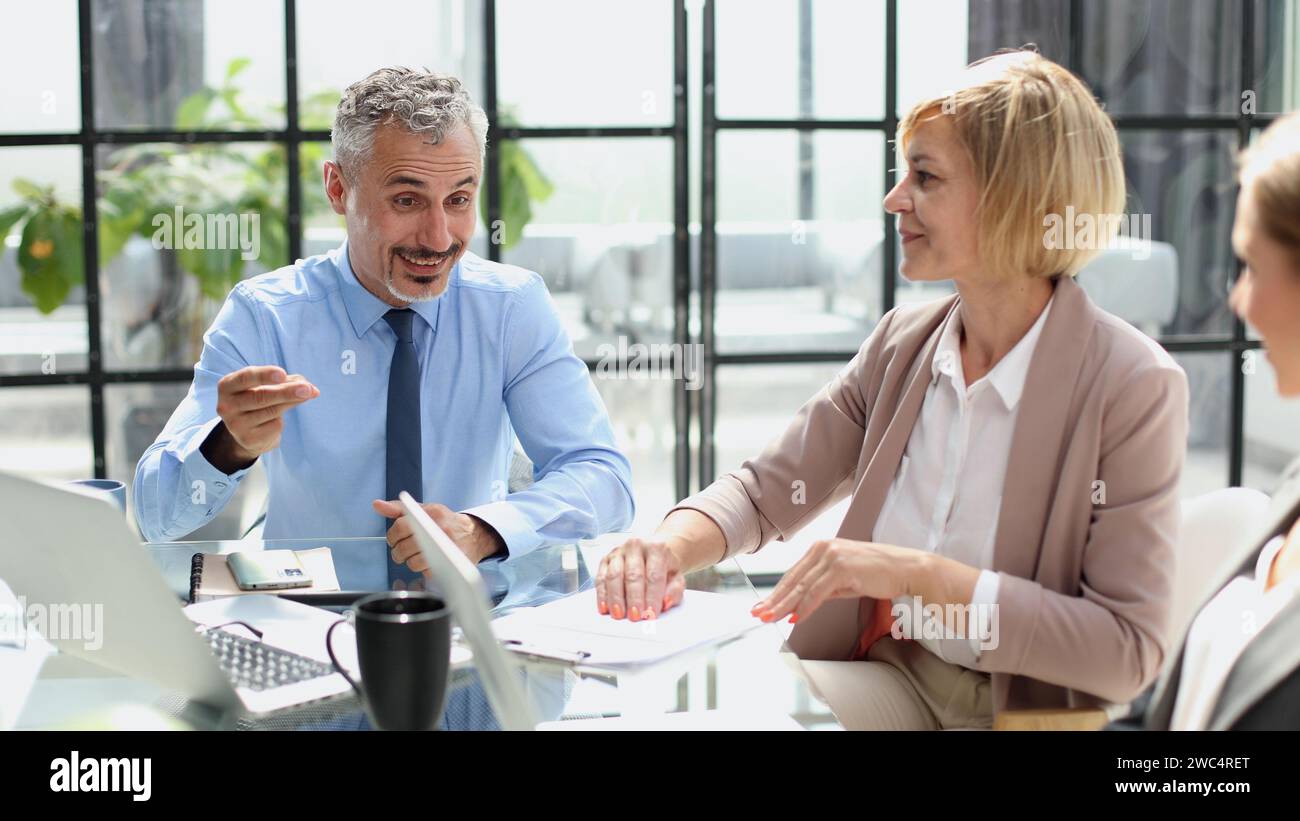 Group standing around desk in hi-res stock photography and images - Alamy