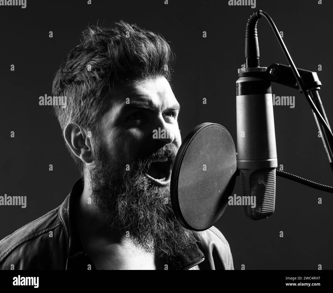 Closeup portrait of man with microphone singing song. Musician in music ...