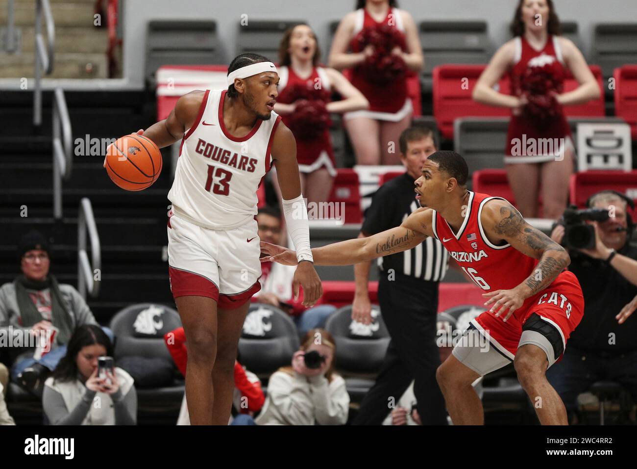 Washington State forward Isaac Jones (13) controls the ball while pressured by Arizona forward ...