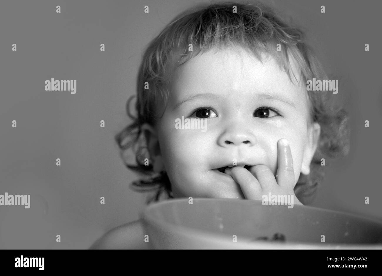 Smiling baby eating food. Healthy nutrition for kids. Funny child face ...