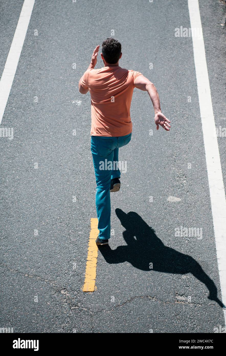 Back view of man running on the road. Active healthy runner jogging ...
