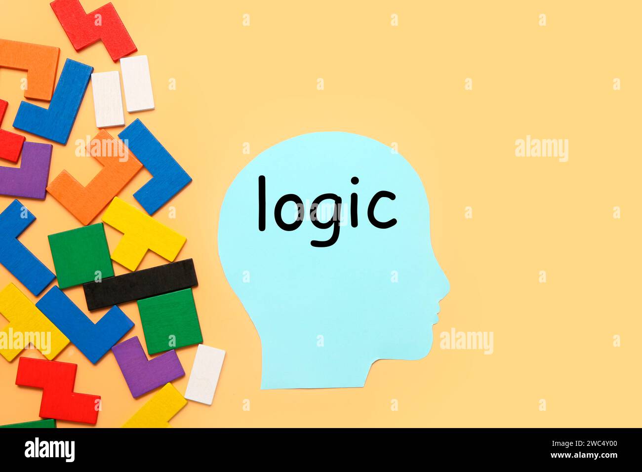 Paper human head with word LOGIC and colorful blocks on beige ...