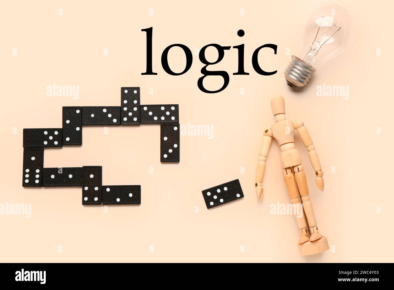 Wooden human figurine, light bulb, dominoes and word LOGIC on beige ...