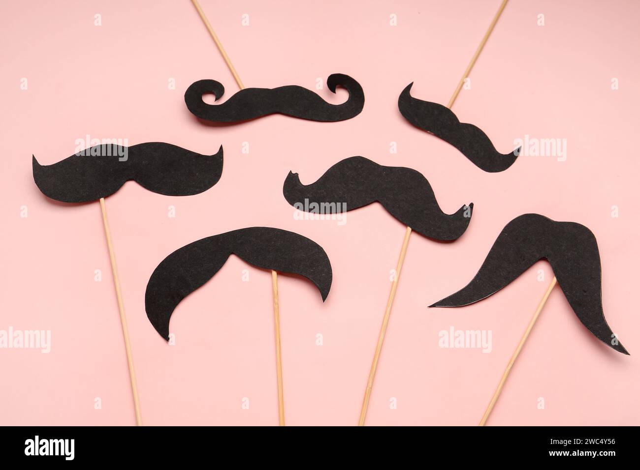 Wooden sticks with different paper mustaches on pink background Stock ...
