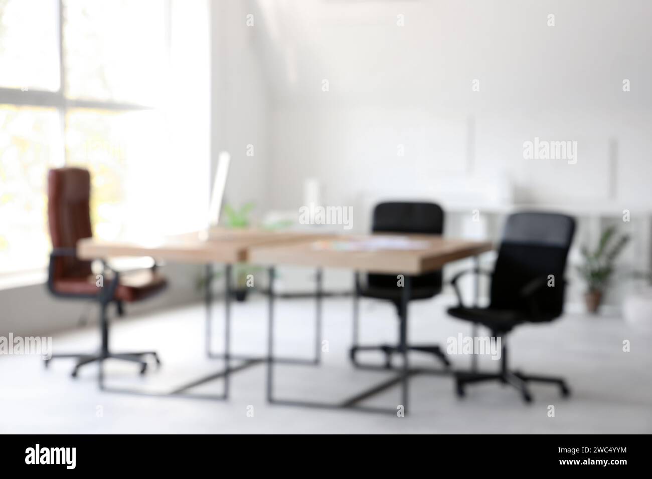 Blurred view of modern office with desks Stock Photo - Alamy