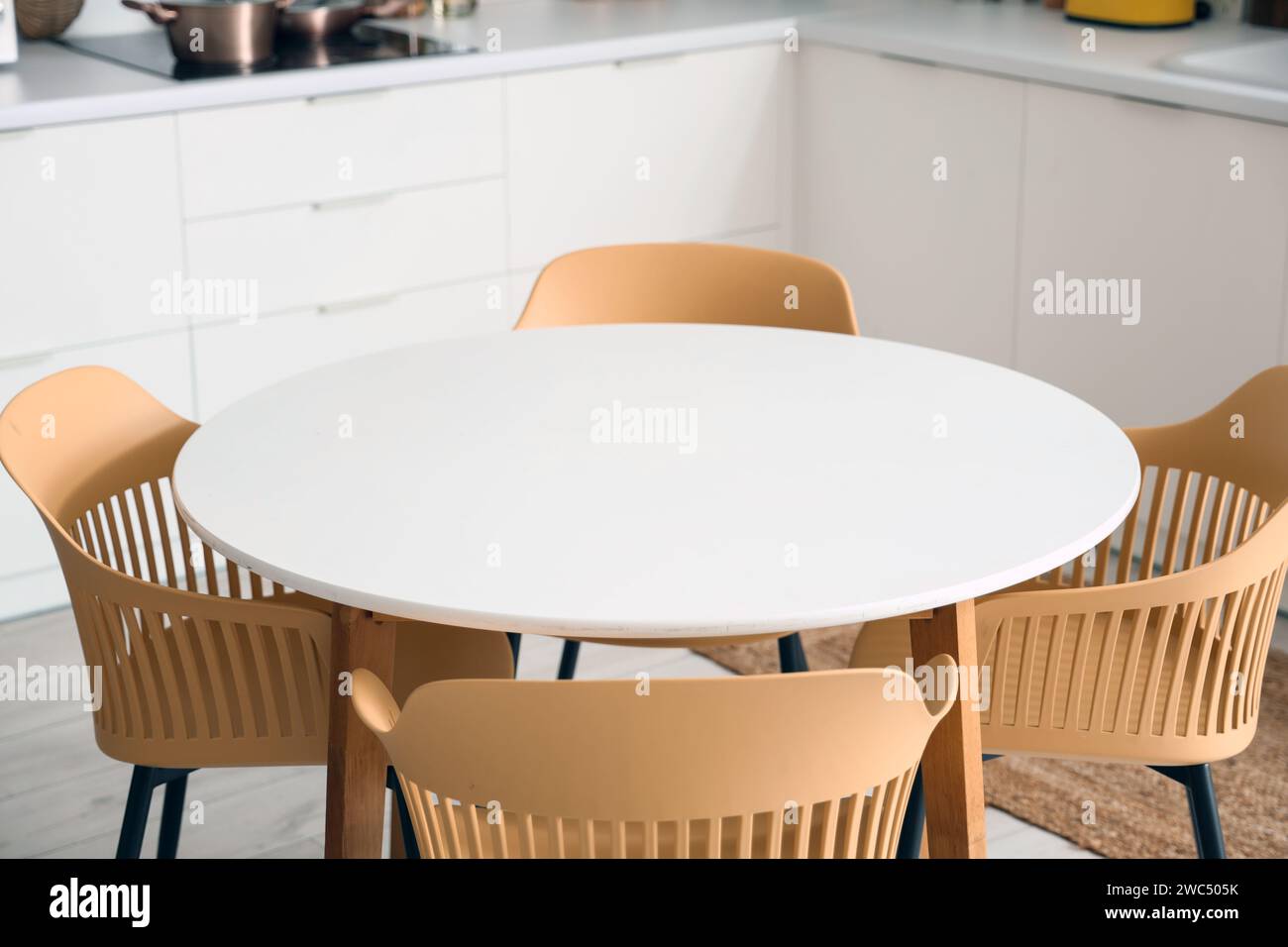 Clean white table in interior of modern kitchen Stock Photo - Alamy