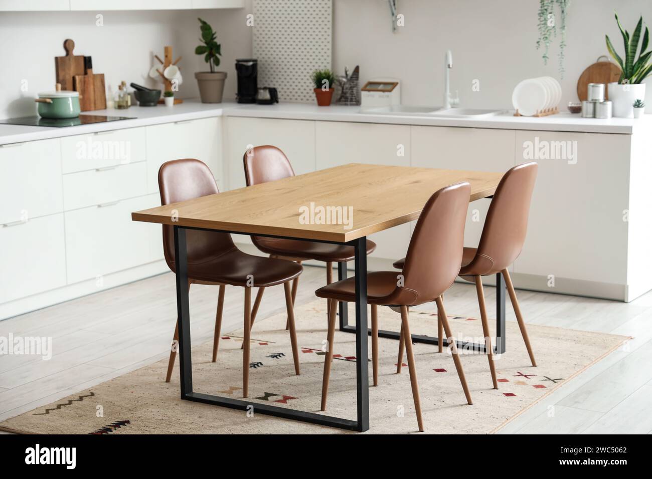 Clean wooden table in interior of modern kitchen Stock Photo - Alamy