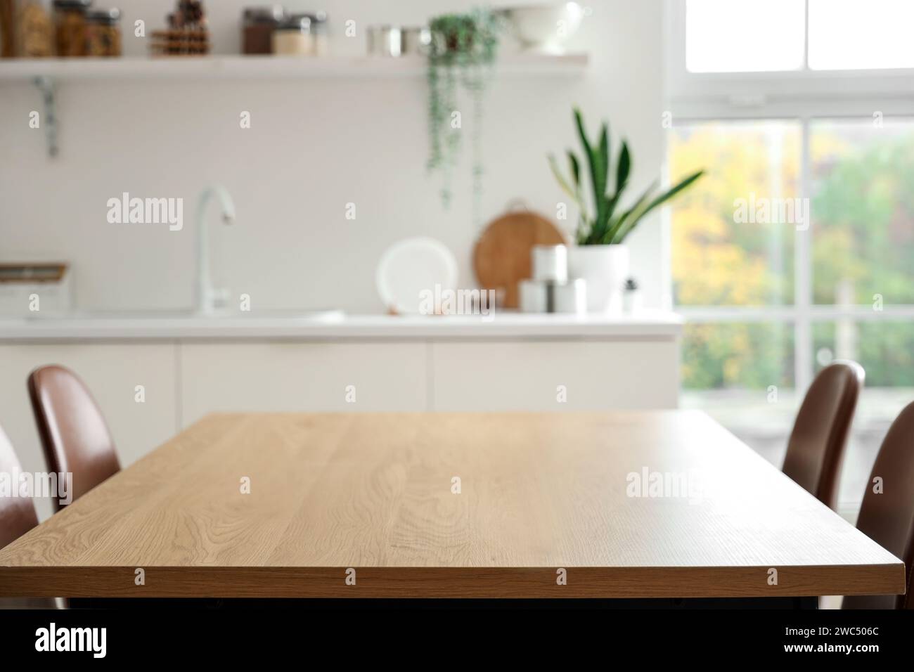 Clean wooden table in interior of modern kitchen Stock Photo - Alamy