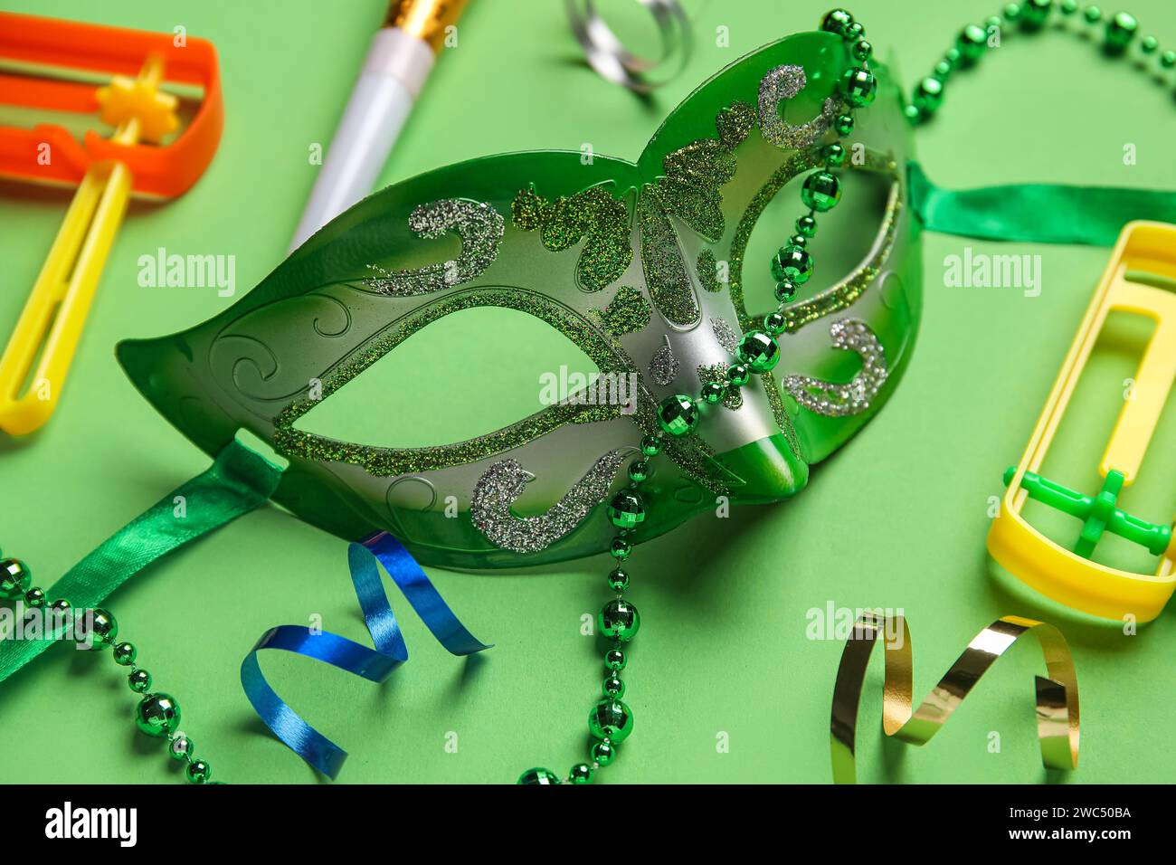 Carnival mask with decor on green background Stock Photo - Alamy