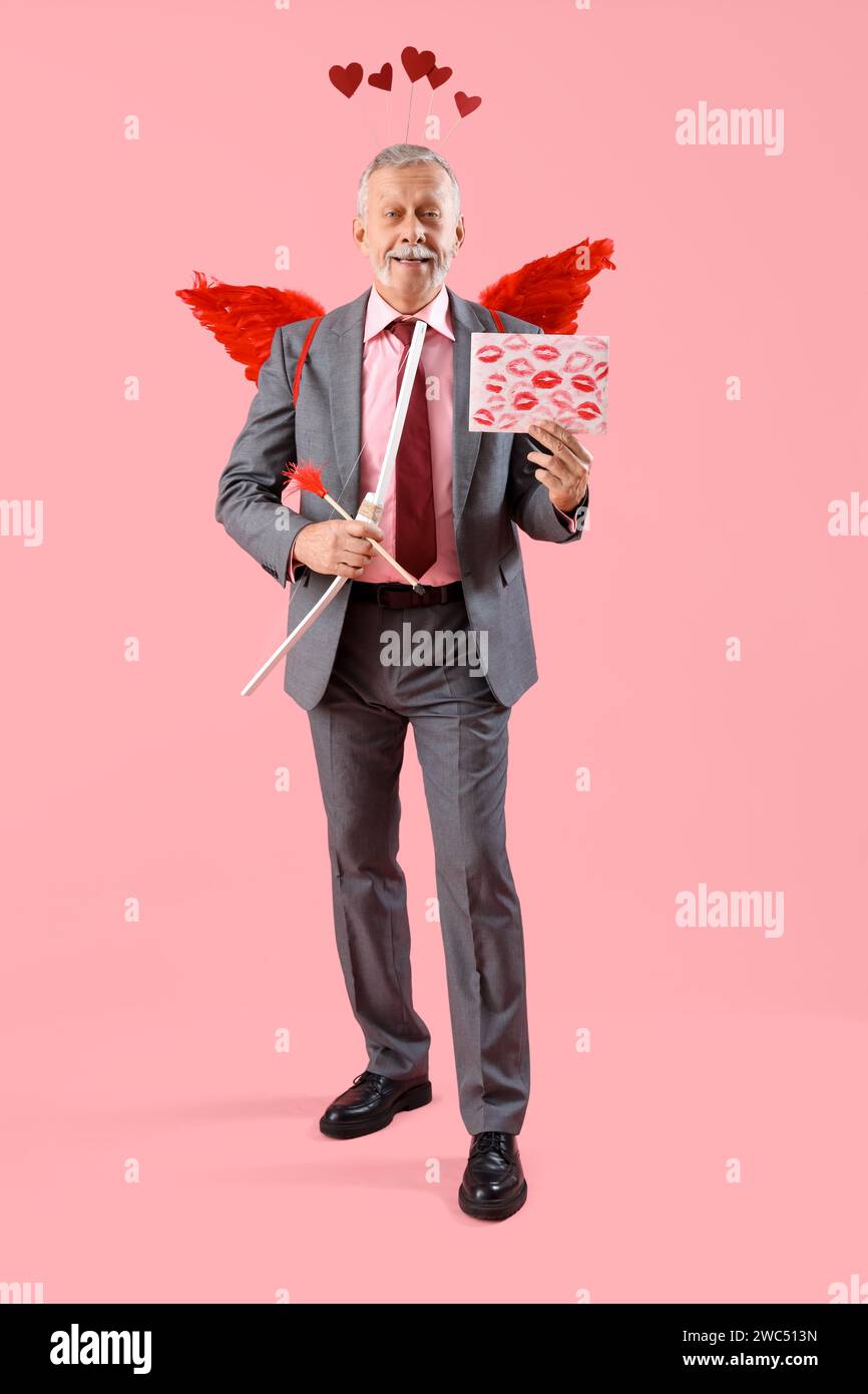 Mature man dressed as Cupid holding letter with lipstick kiss marks and ...