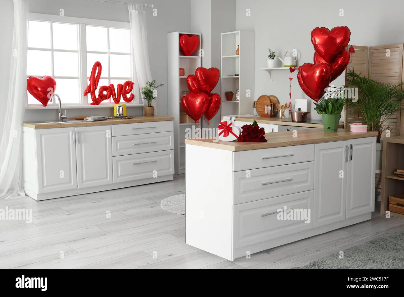 Interior of light kitchen decorated for Valentine's Day with counters ...