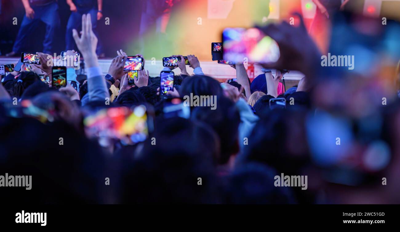 Audience taking videos and photos of performances on stage using ...
