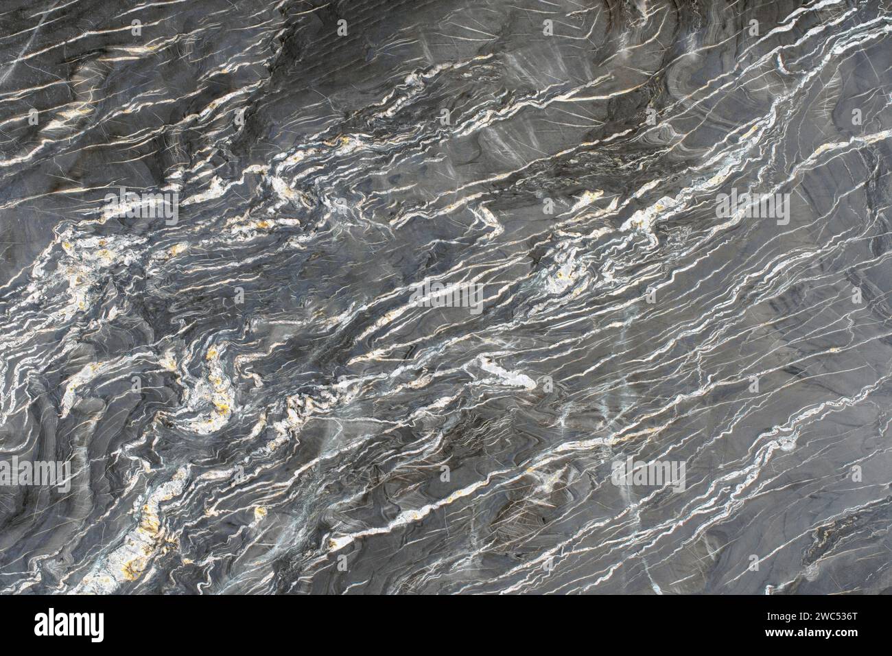 Granite rock on the cut, gray color with light layers, high quality ...