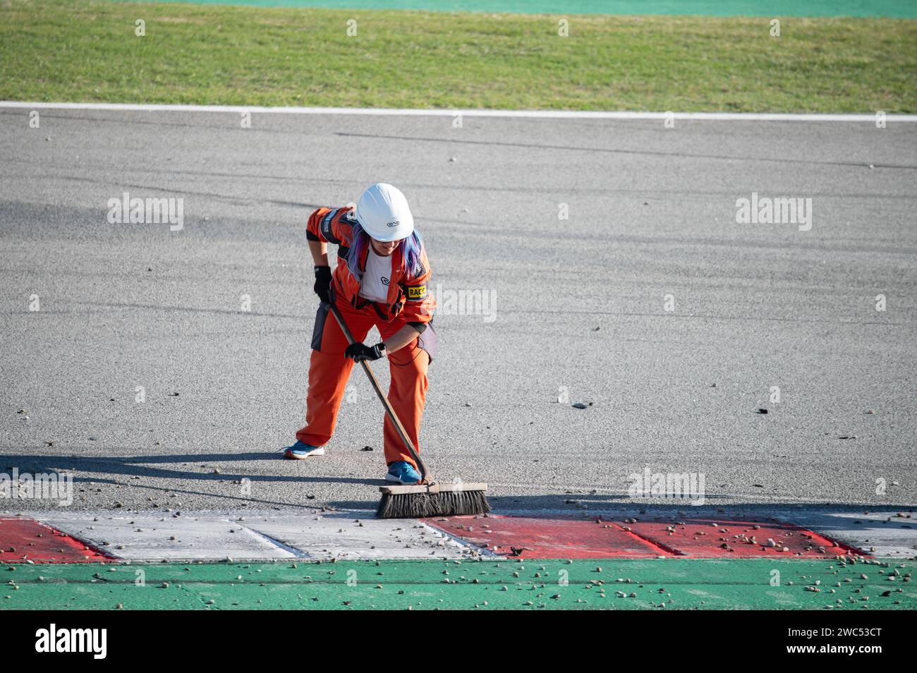 The tack marshall sweeping the remains of a car from an accident and ...