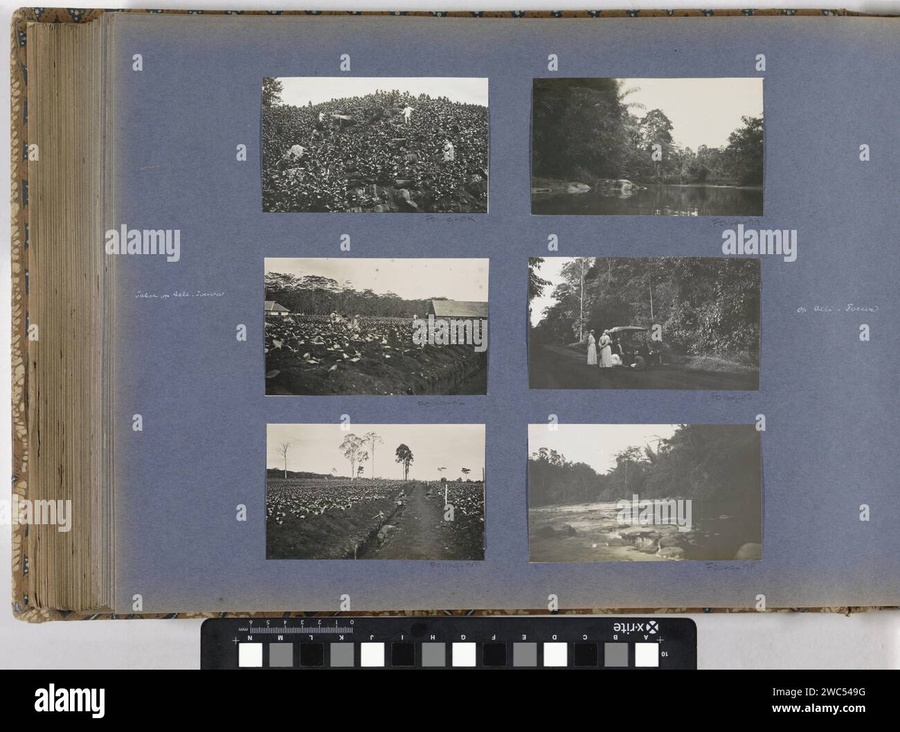 Four people with car trouble on a road at Deli-Toewa on Sumatra ...