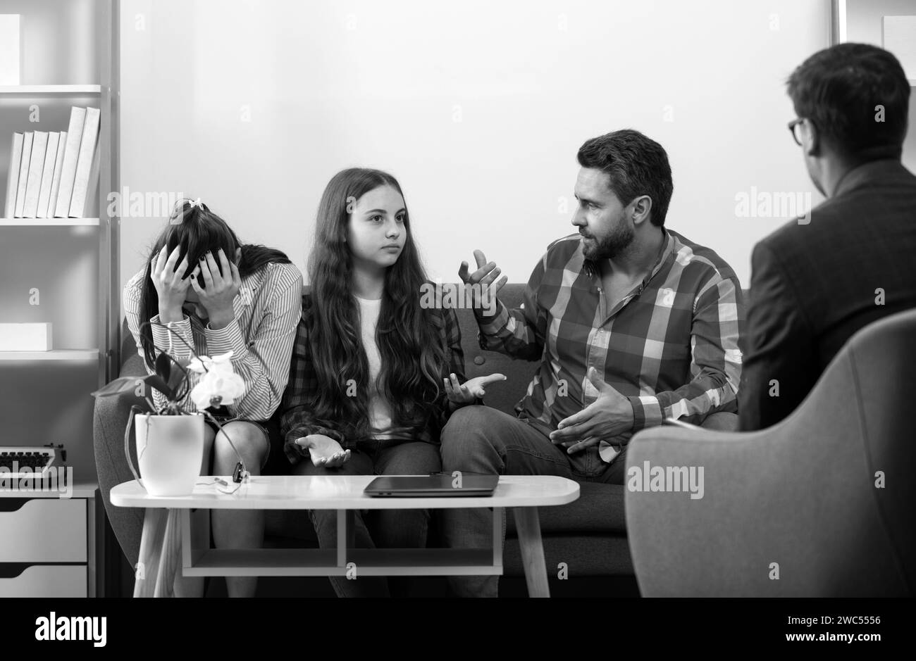 Family at psychology session. Psychologist helping young family with a ...