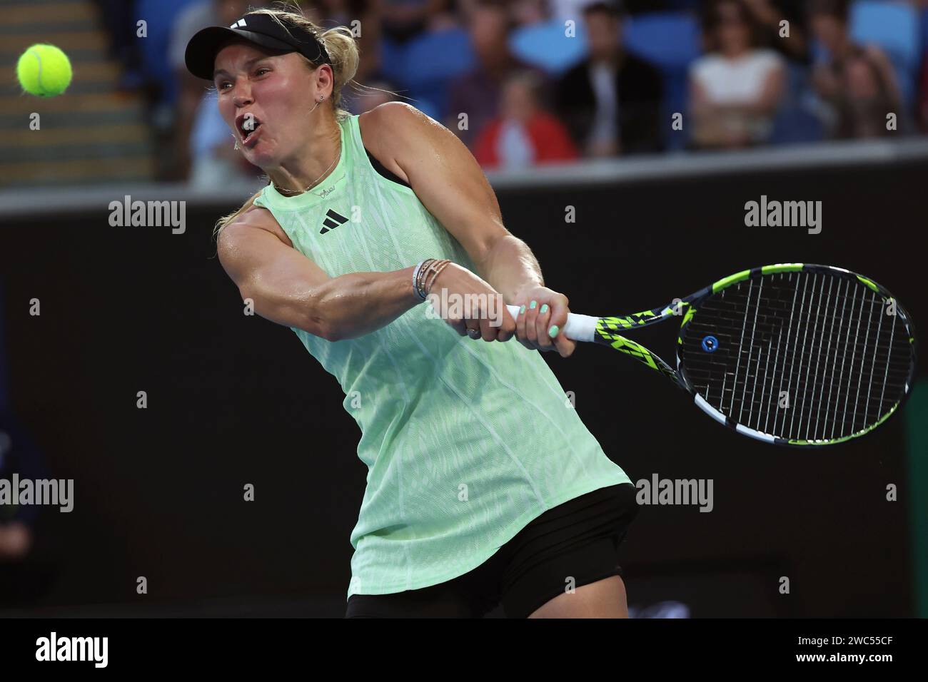 Caroline Wozniacki of Denmark plays a backhand return to Magda Linette ...