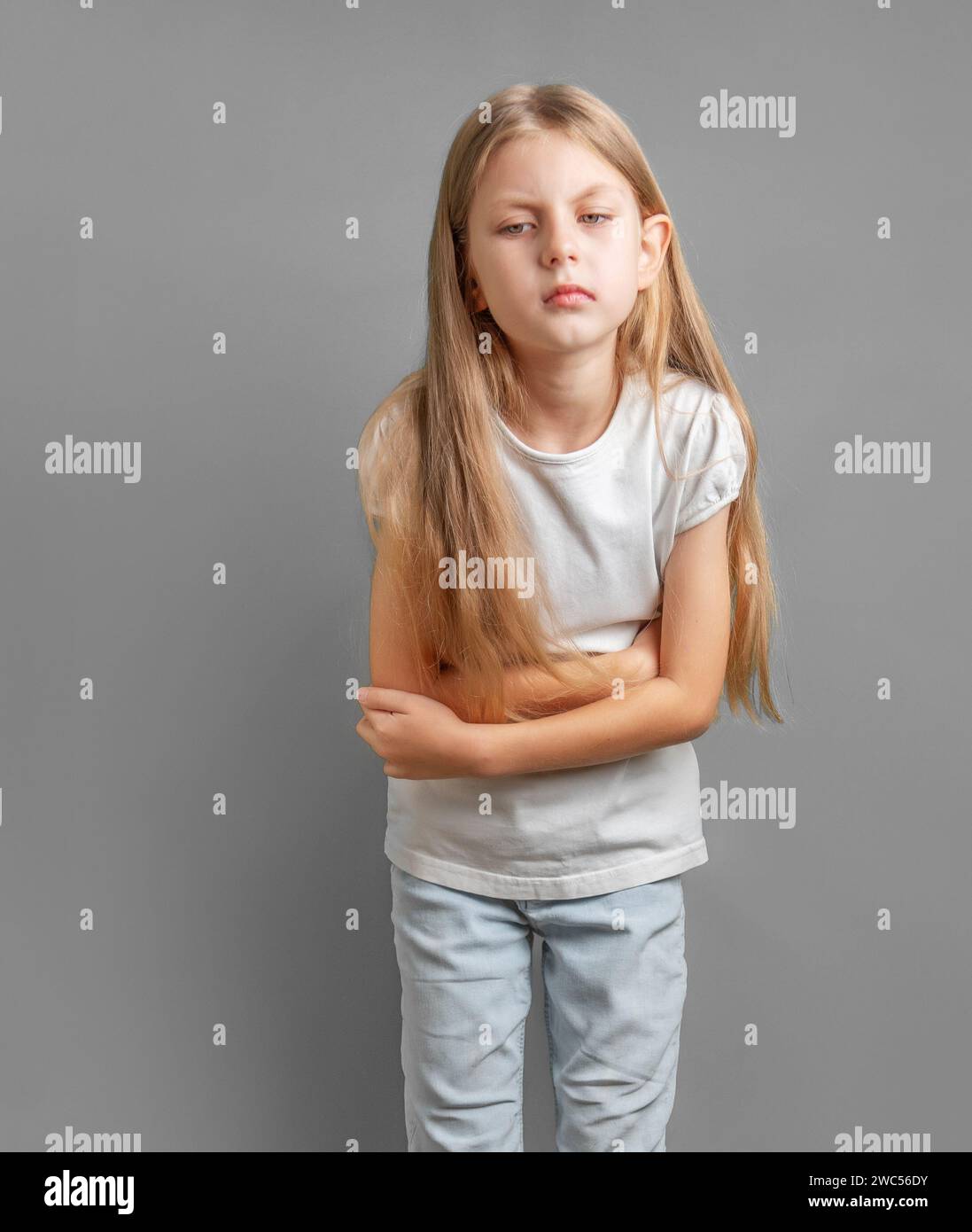 Little girl holding her stomach. Abdominal pain Stock Photo - Alamy