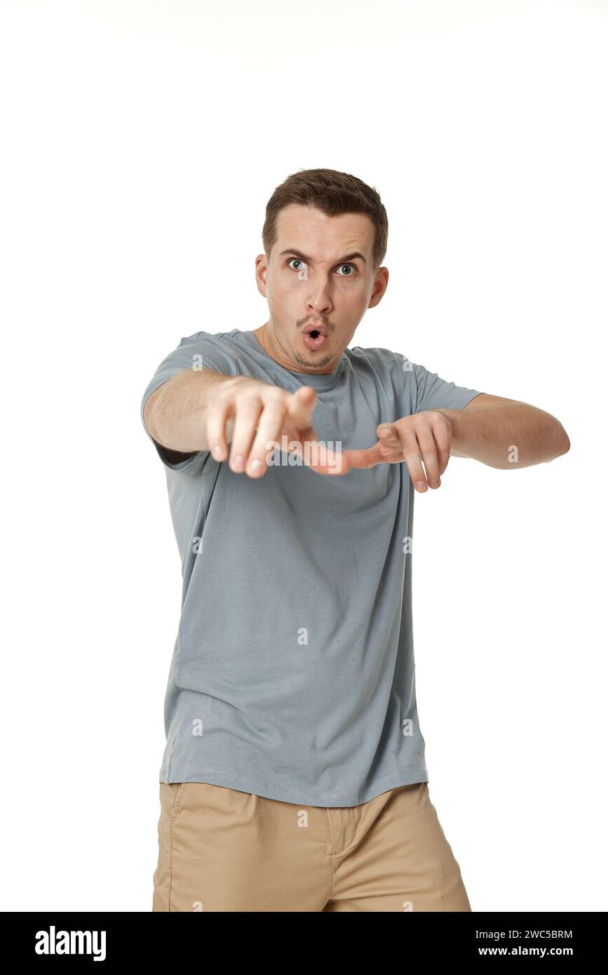 surprised guy pointing at the camera on white studio background Stock ...