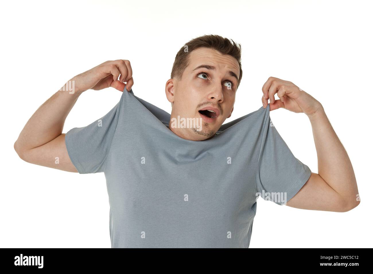 man holding himself by the shoulders isolated on white background Stock ...
