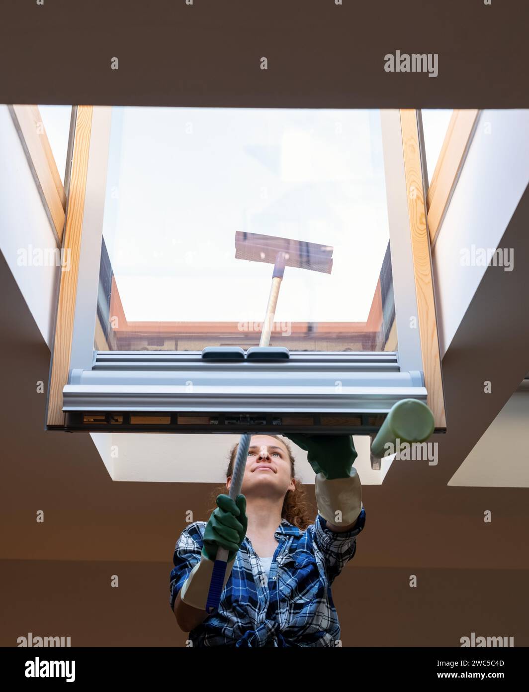 Woman washing roof window at home. Doing housework Stock Photo - Alamy