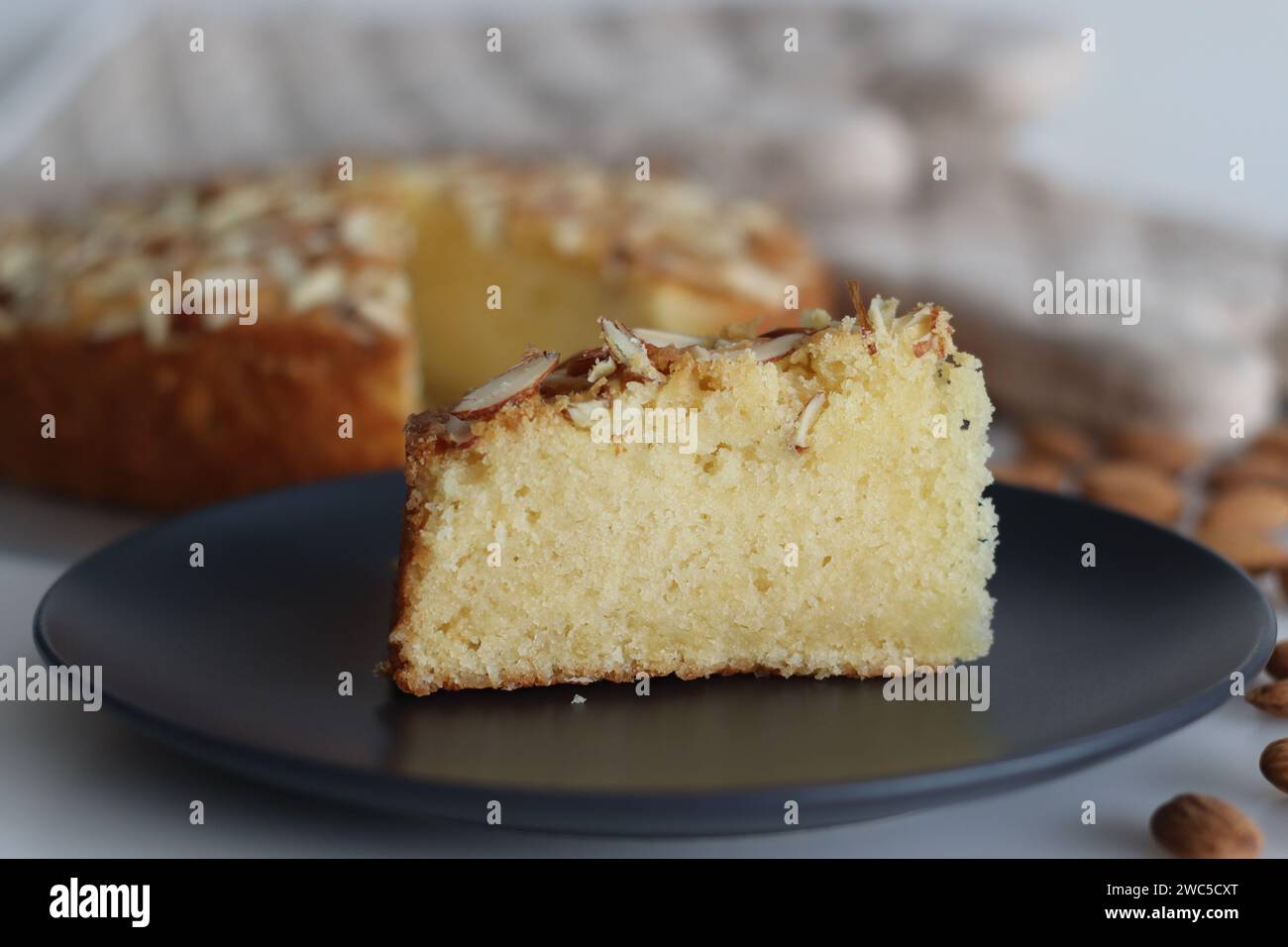 Sliced almond buttermilk cake. A delicious cake adorned with a generous ...