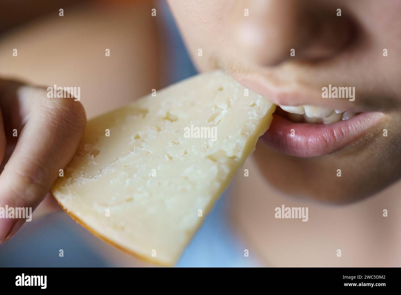 Closeup of crop teenage girl eating fresh cheese at home Stock Photo ...