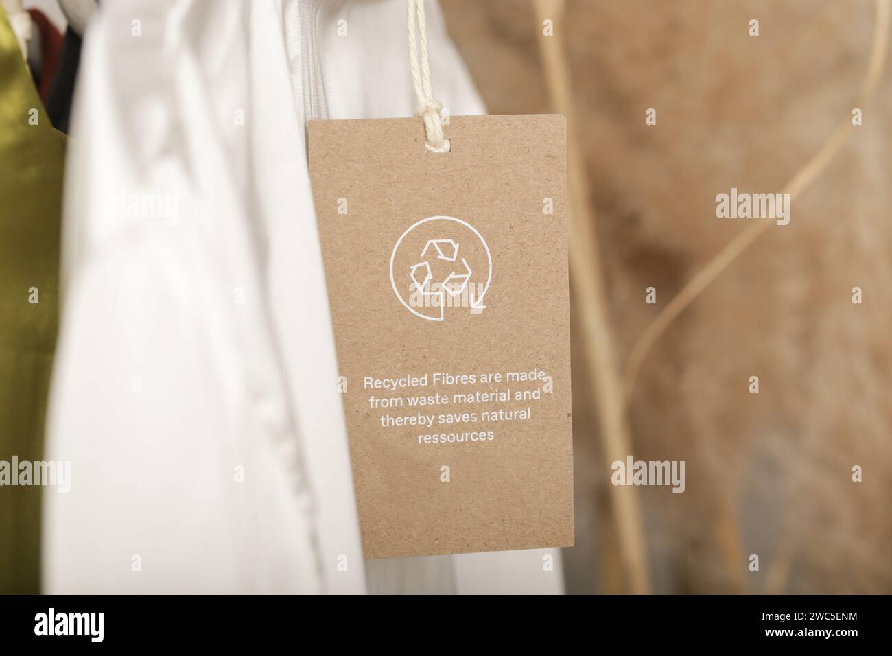 Close up of clothing tag with recycle icon. Recycling products concept ...