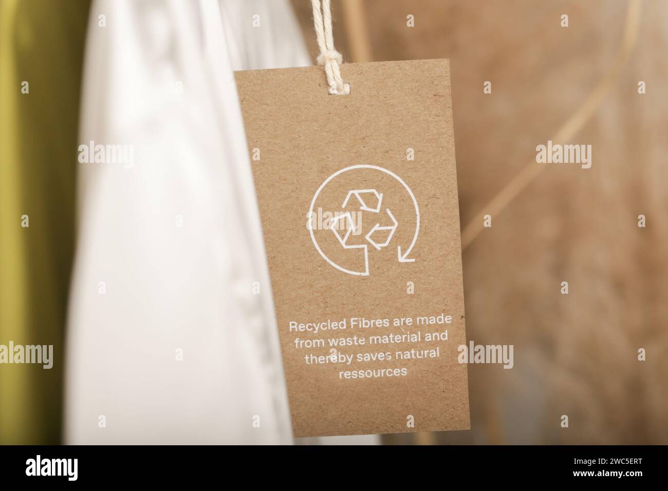 Close up of clothing tag with recycle icon. Recycling products concept ...