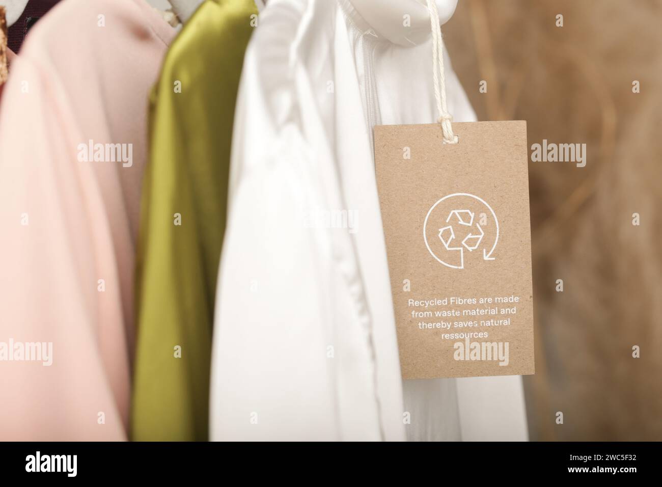 Close up of clothing tag with recycle icon. Recycling products concept ...