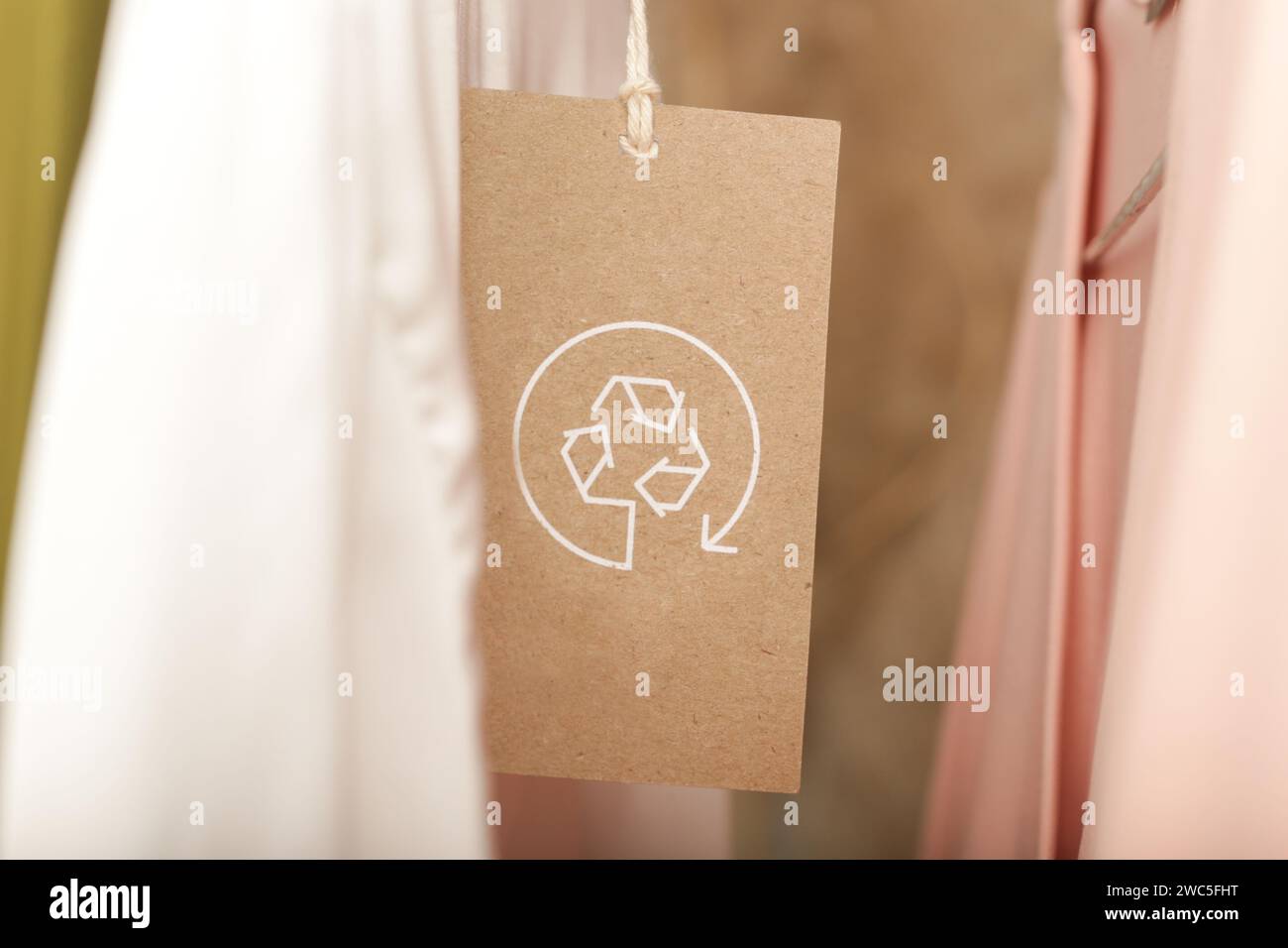 Close up of clothing tag with recycle icon. Recycling products concept ...