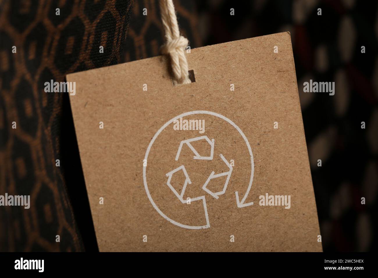 Close up of clothing tag with recycle icon. Recycling products concept ...
