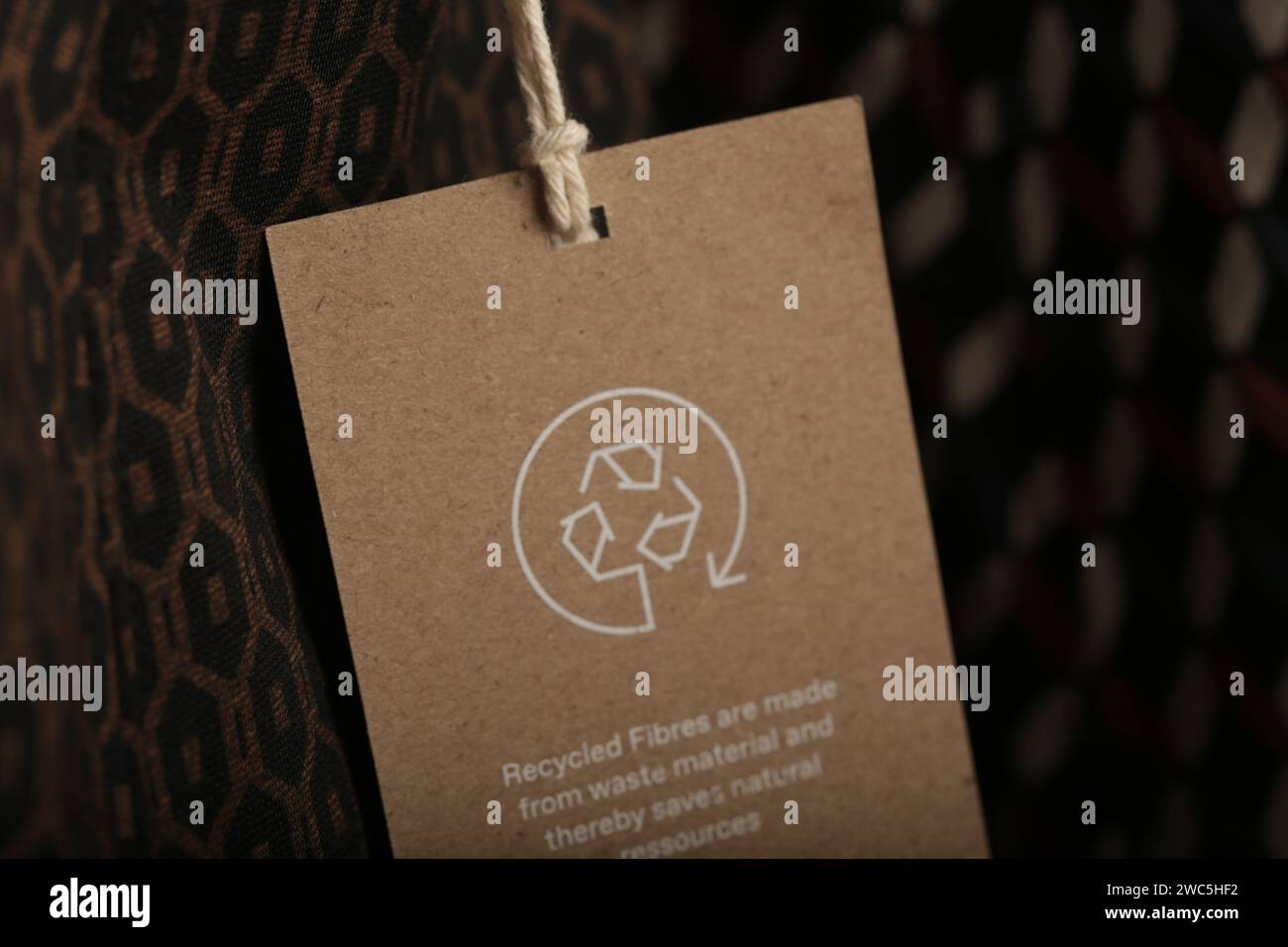Close up of clothing tag with recycle icon. Recycling products concept ...