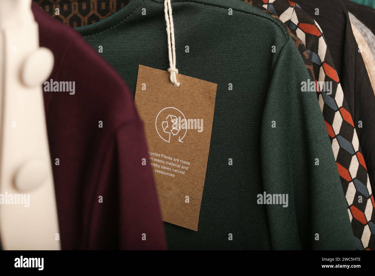 Close up of clothing tag with recycle icon. Recycling products concept ...