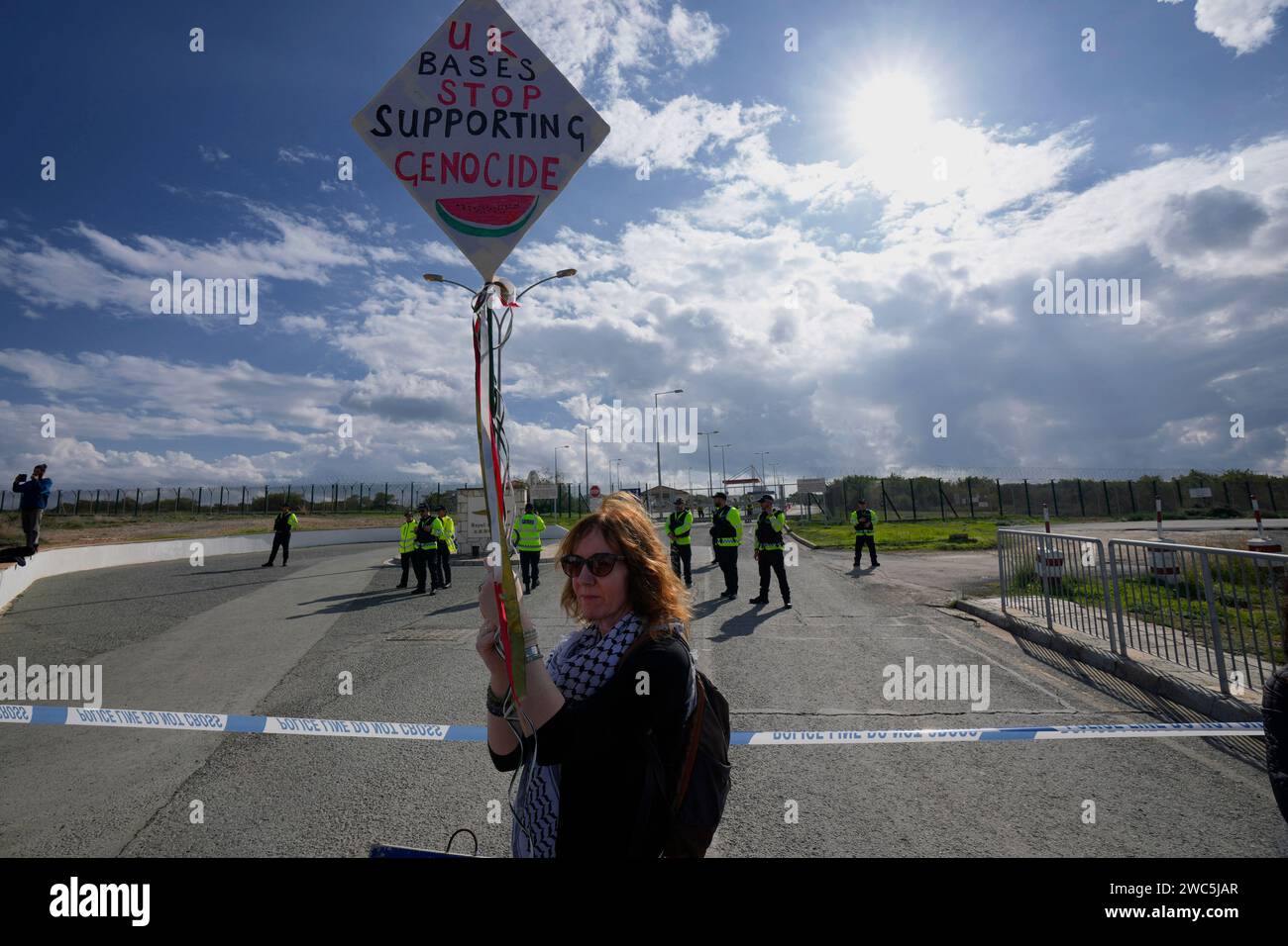 A demonstrator holds a placard, condemning Israel's military operations ...