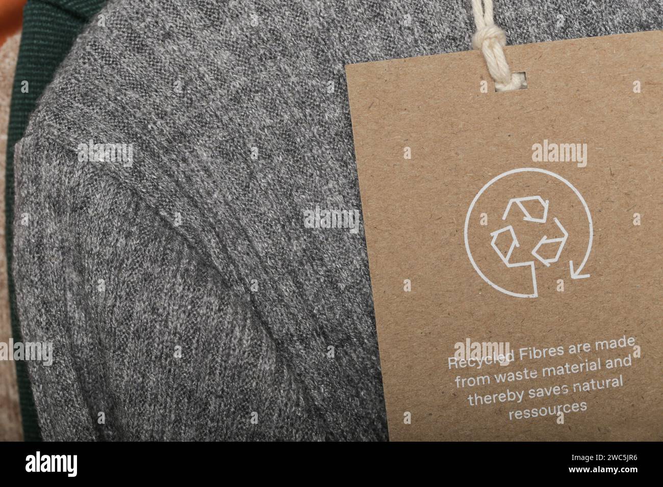 Close up of clothing tag with recycle icon. Recycling products concept ...