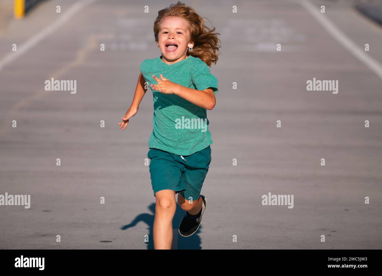Cheerful boy running to school. Kids run race Stock Photo - Alamy