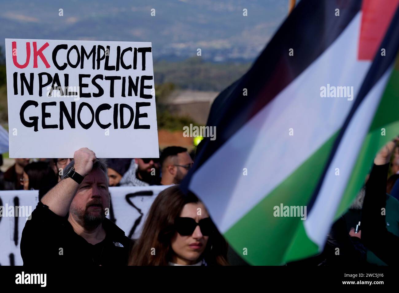 Demonstrators shout slogans, as they hold placards condemning Israel's ...