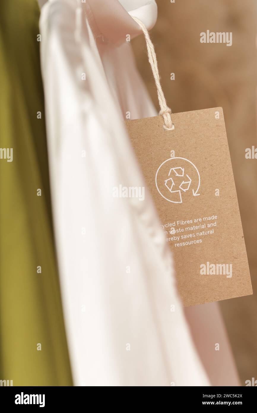 Close up of clothing tag with recycle icon. Recycling products concept ...