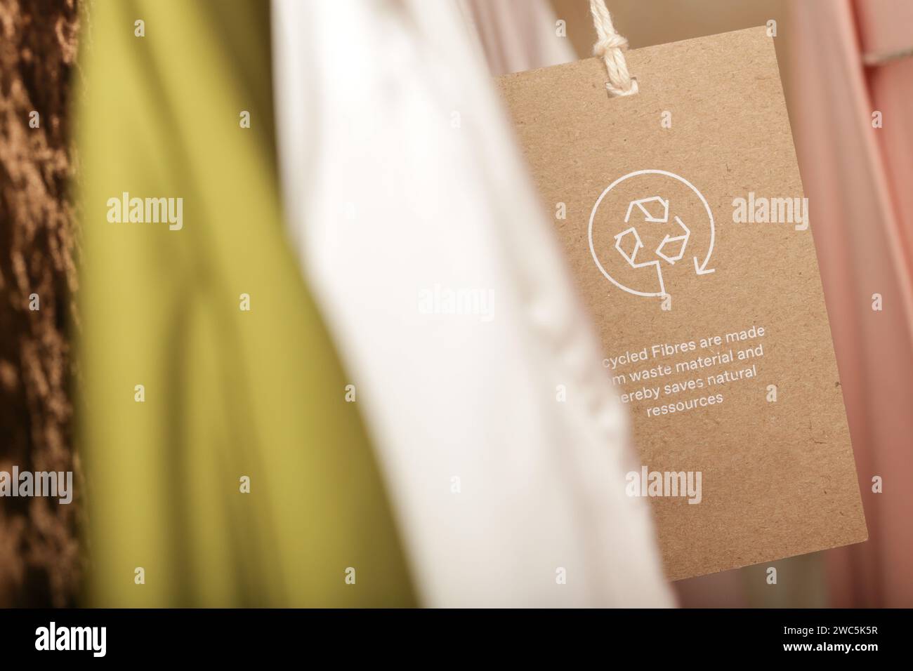 Close up of clothing tag with recycle icon. Recycling products concept ...