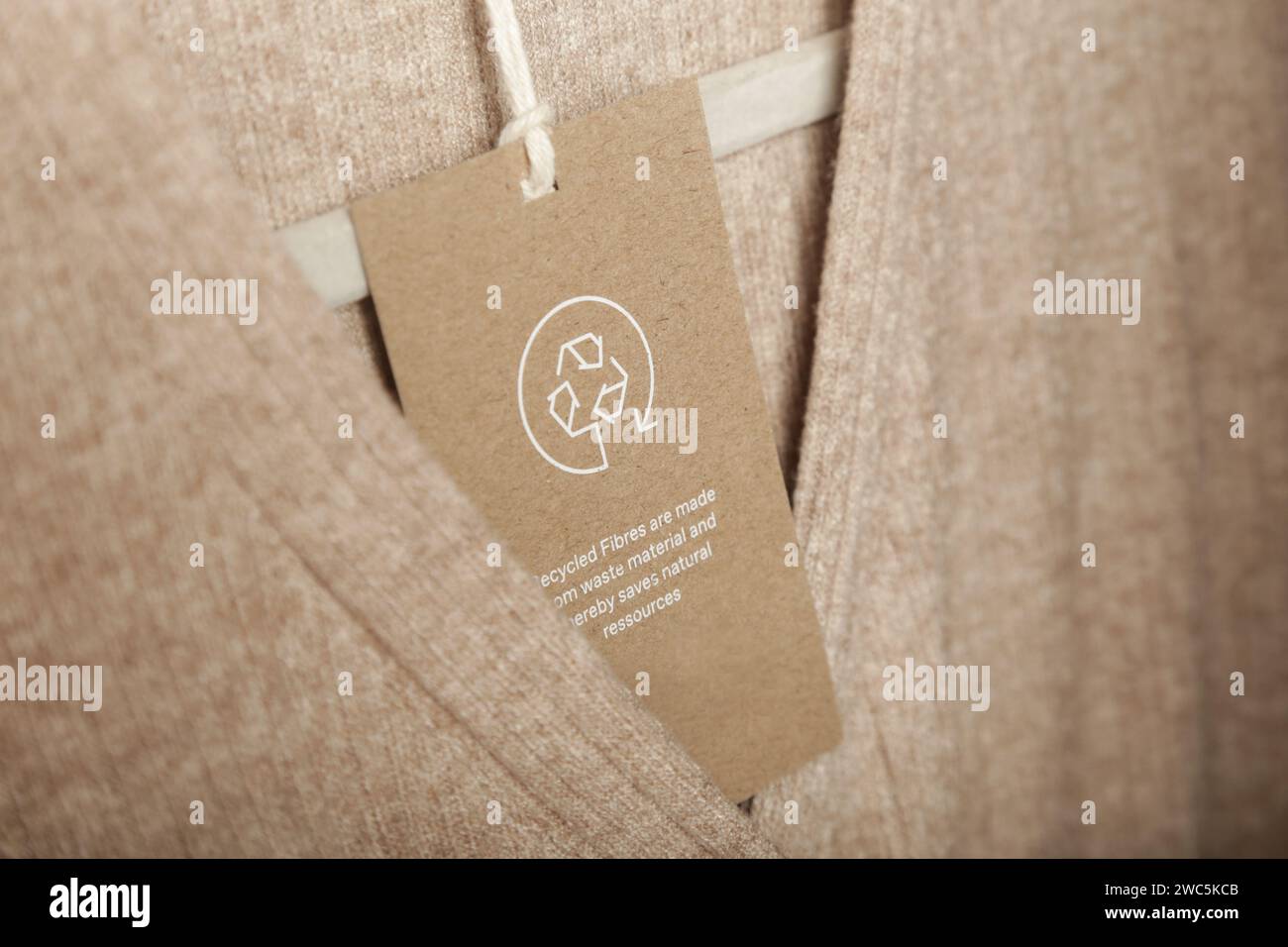 Close up of clothing tag with recycle icon. Recycling products concept ...
