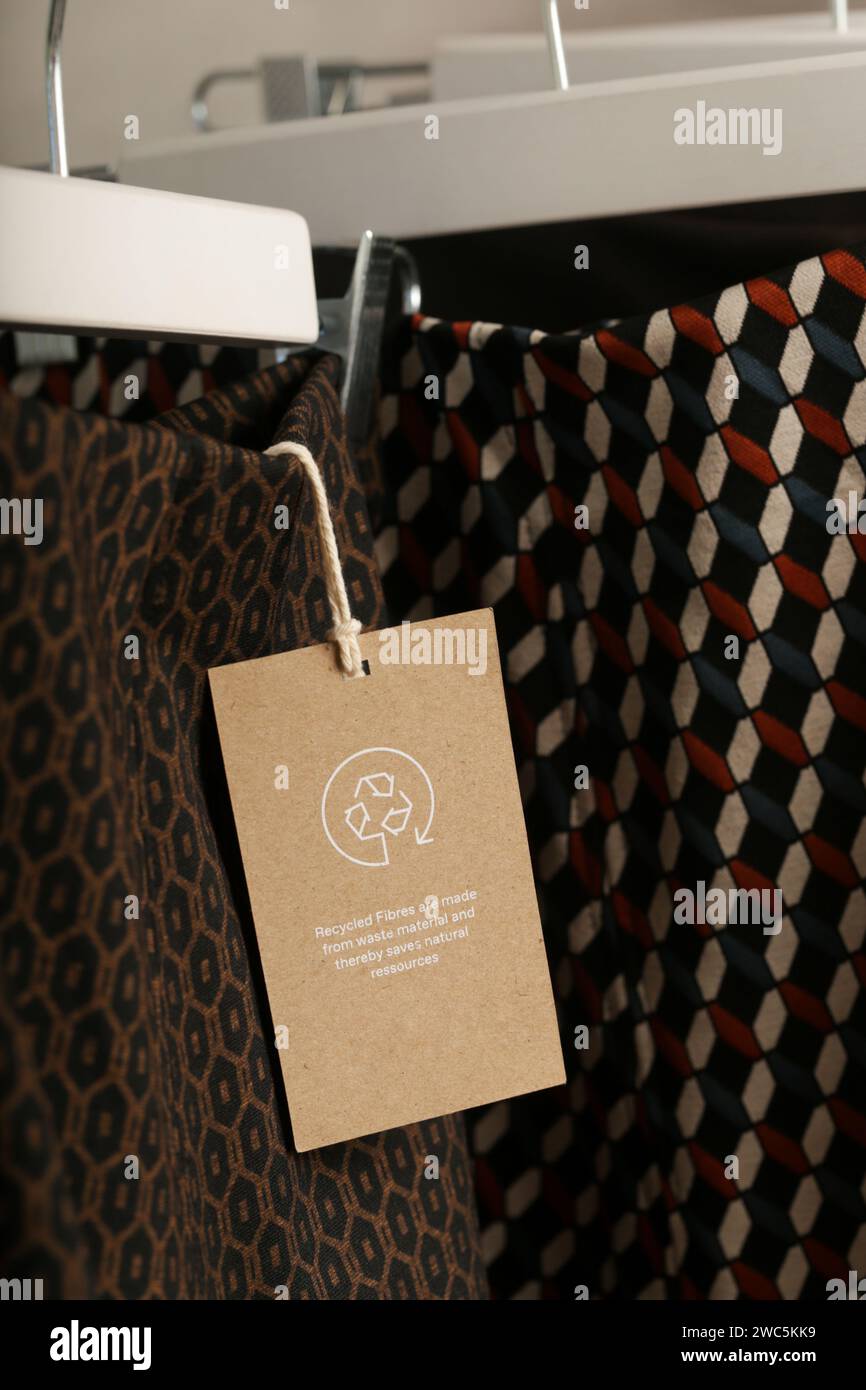 Close up of clothing tag with recycle icon. Recycling products concept ...