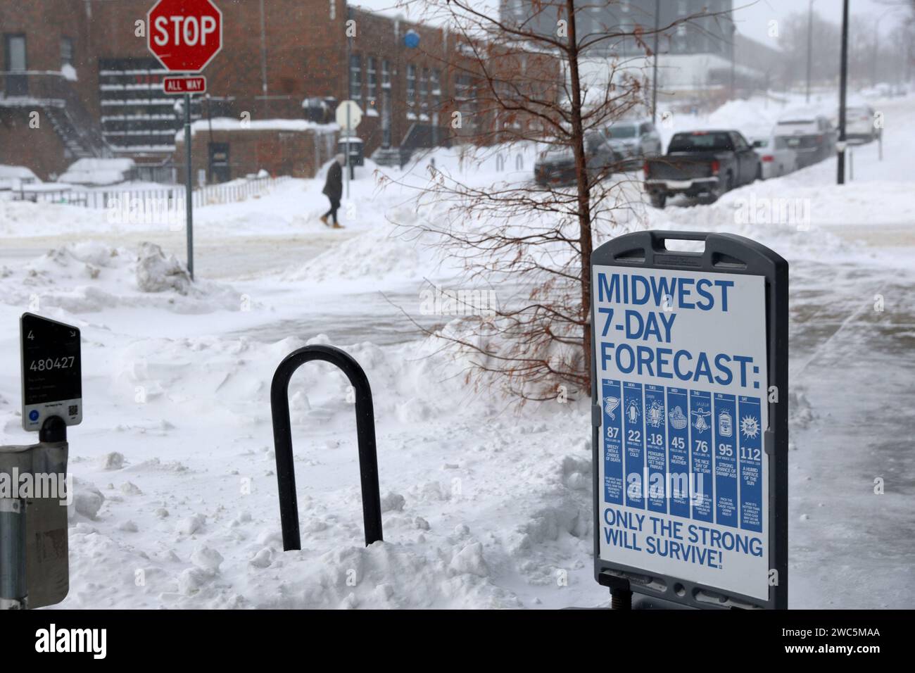 A pedestrian walks during a severe winter storm that brought blizzard ...