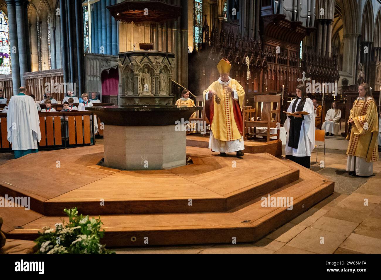 The Right Revd Stephen Lake, Bishop of Salisbury, swings incense during ...