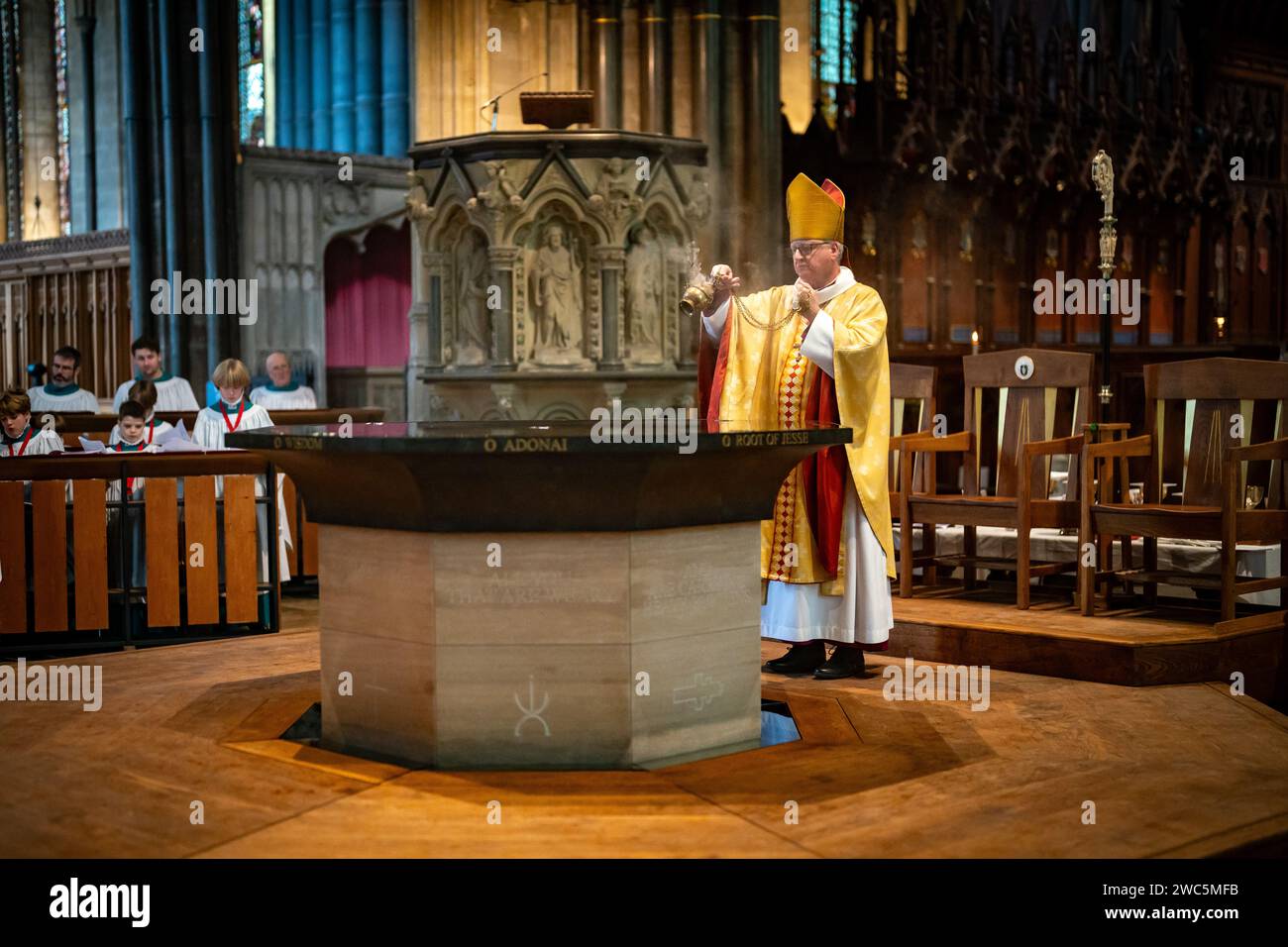 The Right Revd Stephen Lake, Bishop of Salisbury, swings incense during ...