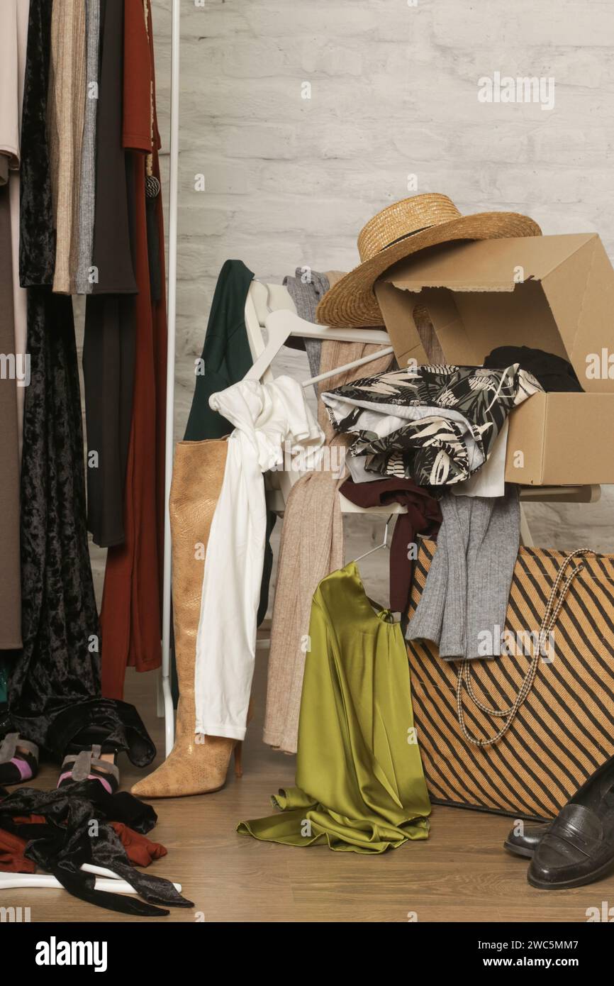 Untidy cluttered woman wardrobe with stylish clothes and accessories ...
