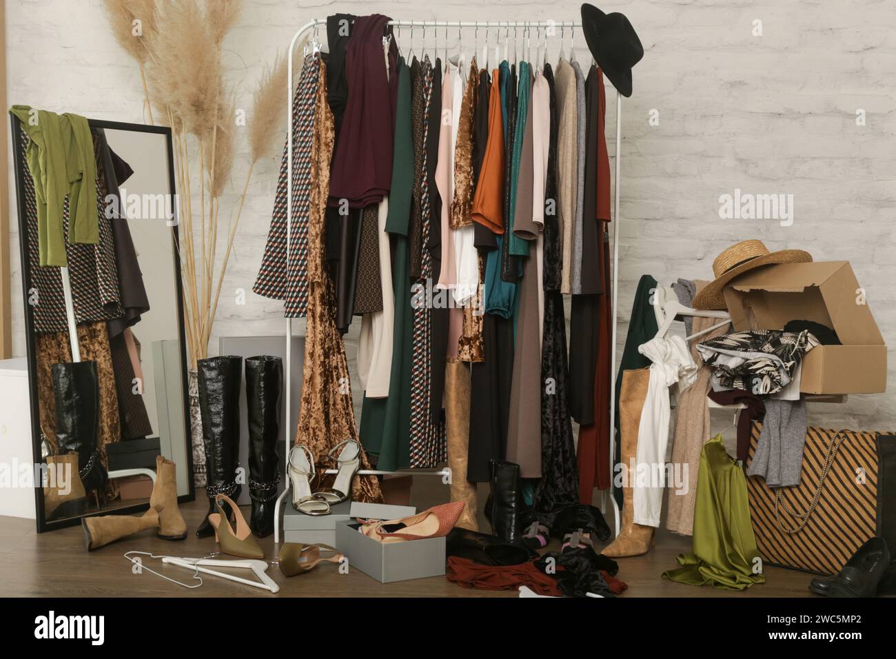 Untidy cluttered woman wardrobe with stylish clothes and accessories ...