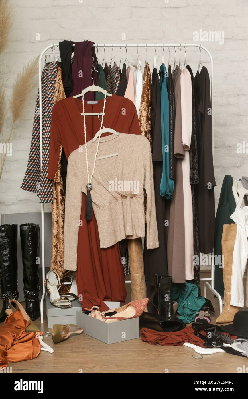 Untidy cluttered woman wardrobe with stylish clothes and accessories ...
