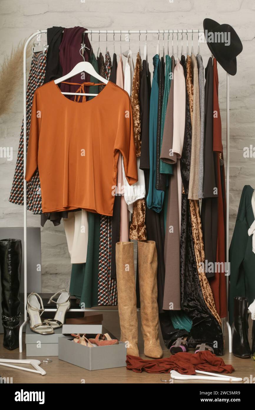Untidy cluttered woman wardrobe with stylish clothes and accessories ...